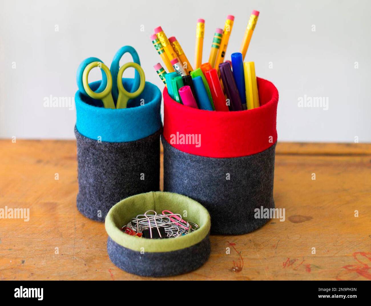 This undated image shows a felt-covered desk set of modern, color ...