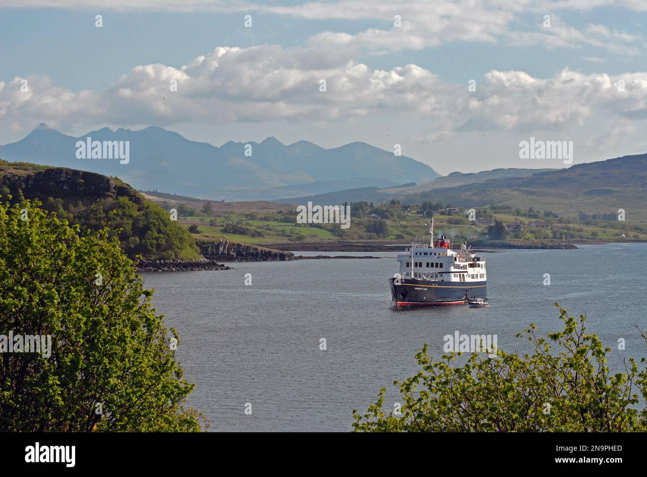 HEBRIDEAN PRINCESS at anchor in PORTREE BAY, with the dramatic backdrop ...