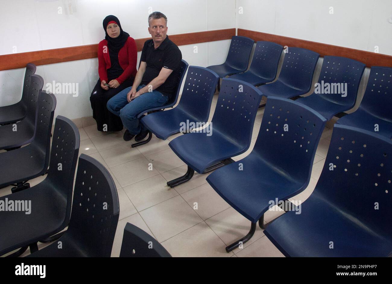 Palestinian activist Bassem Tamimi sits with his wife as they wait for ...
