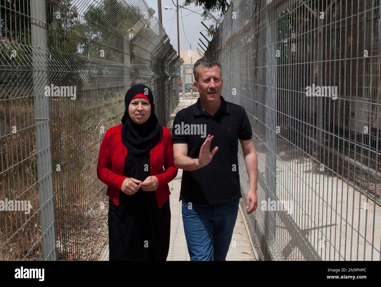 Palestinian activist Bassem Tamimi walks with his wife as they arrive ...