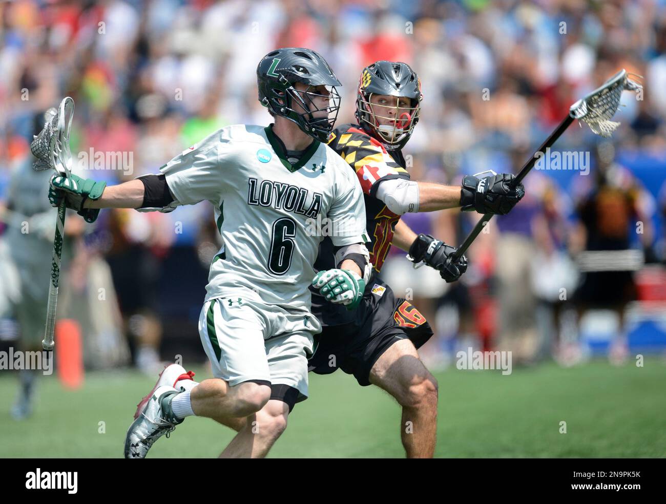 Loyola's Pat Byrnes (6) drives the ball past Maryland's Jesse Bernhardt ...