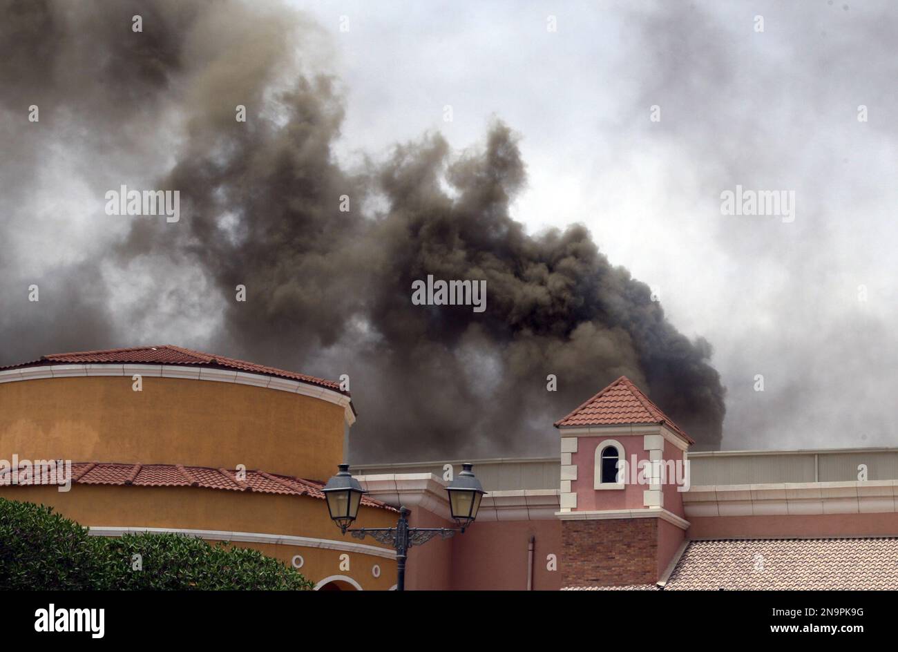 Smoke rises above the Villaggio Mall, in Doha's west end, as a fire ...