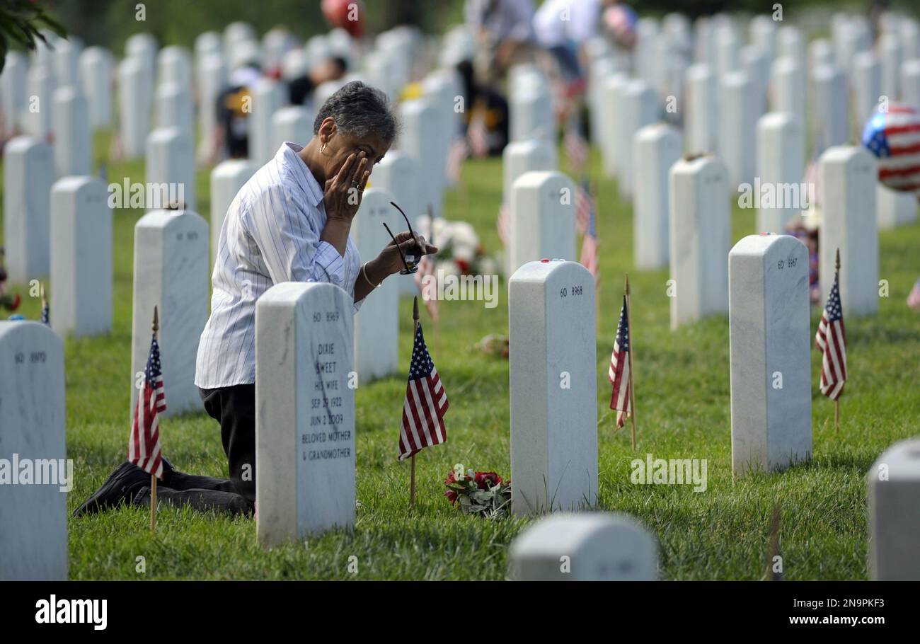 Andrea Bryson, of Woodbridge, Va., wipes tears from her face as she ...