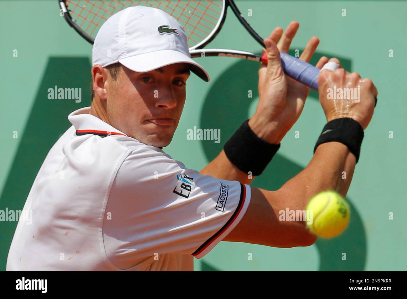 John Isner of the U.S. returns in his first round match against Rogerio ...
