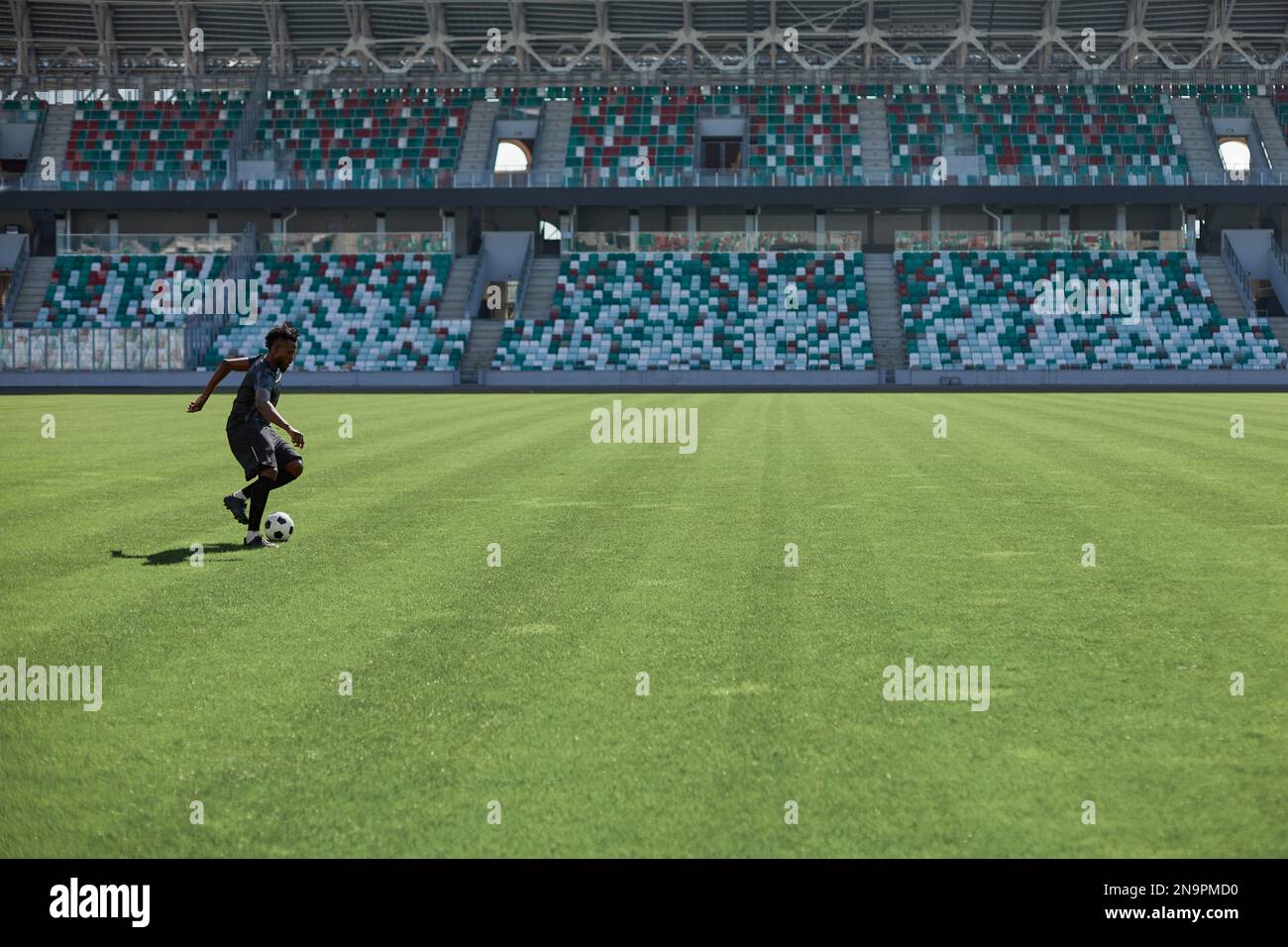 Professional football player in action at the stadium Stock Photo - Alamy