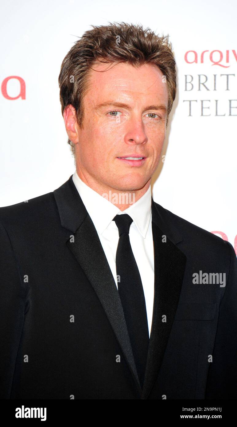 Presenter Toby Stephens pose in front of the winners boards pose in ...