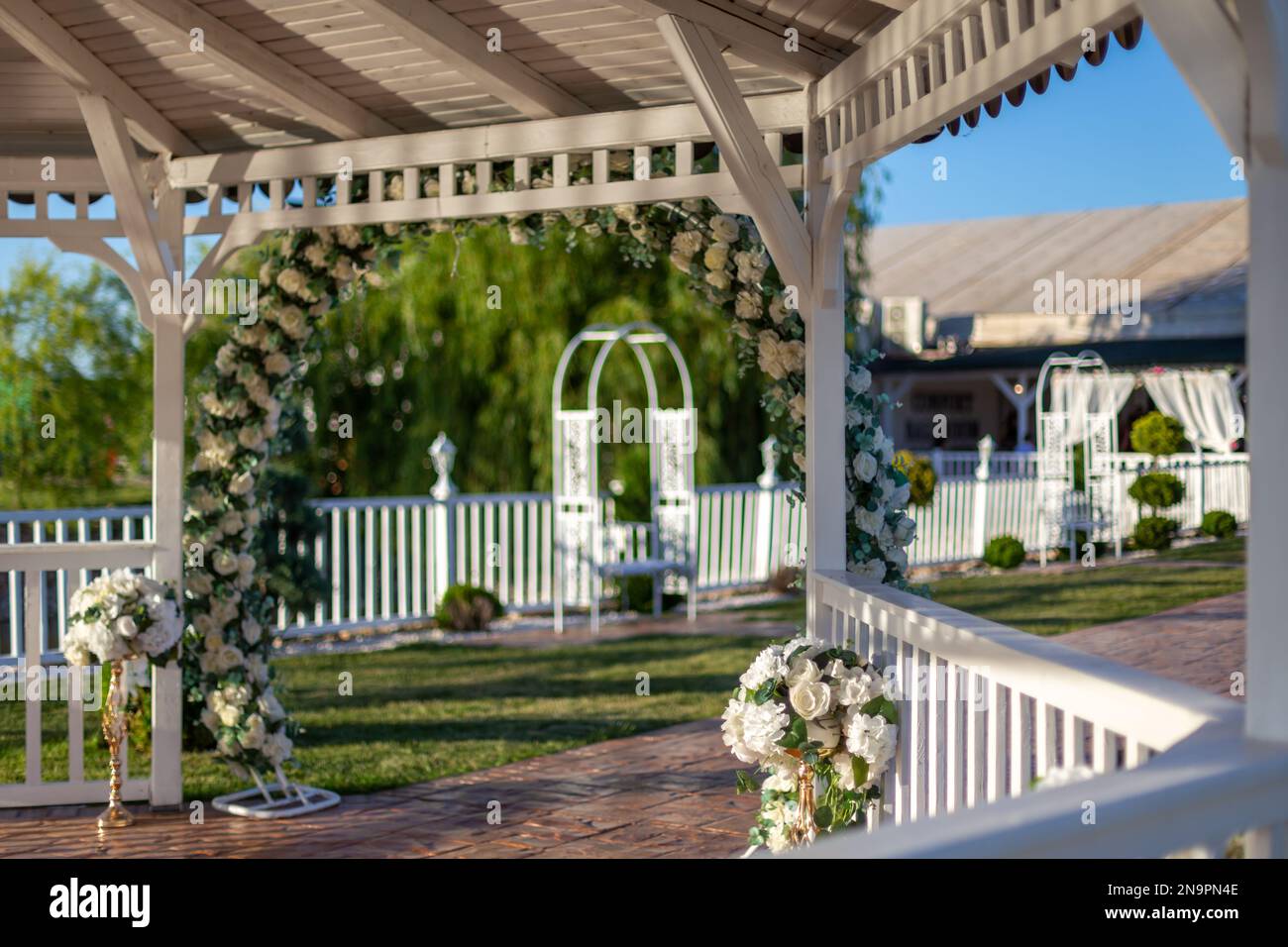 An interior design of round white wedding hall in the garden in the ...