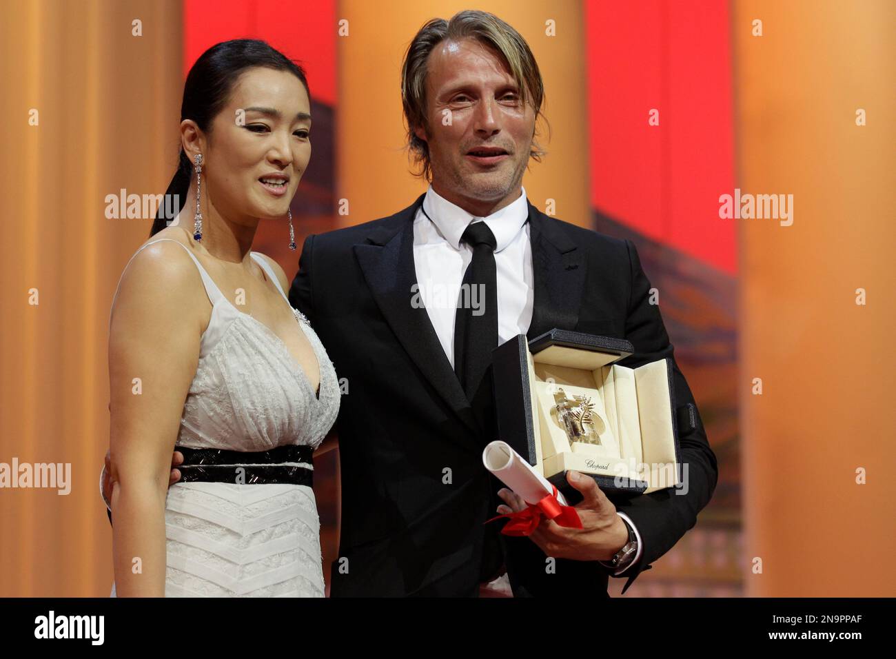 Actor Mads Mikkelsen, right, poses on stage with actress Gong Li as he ...