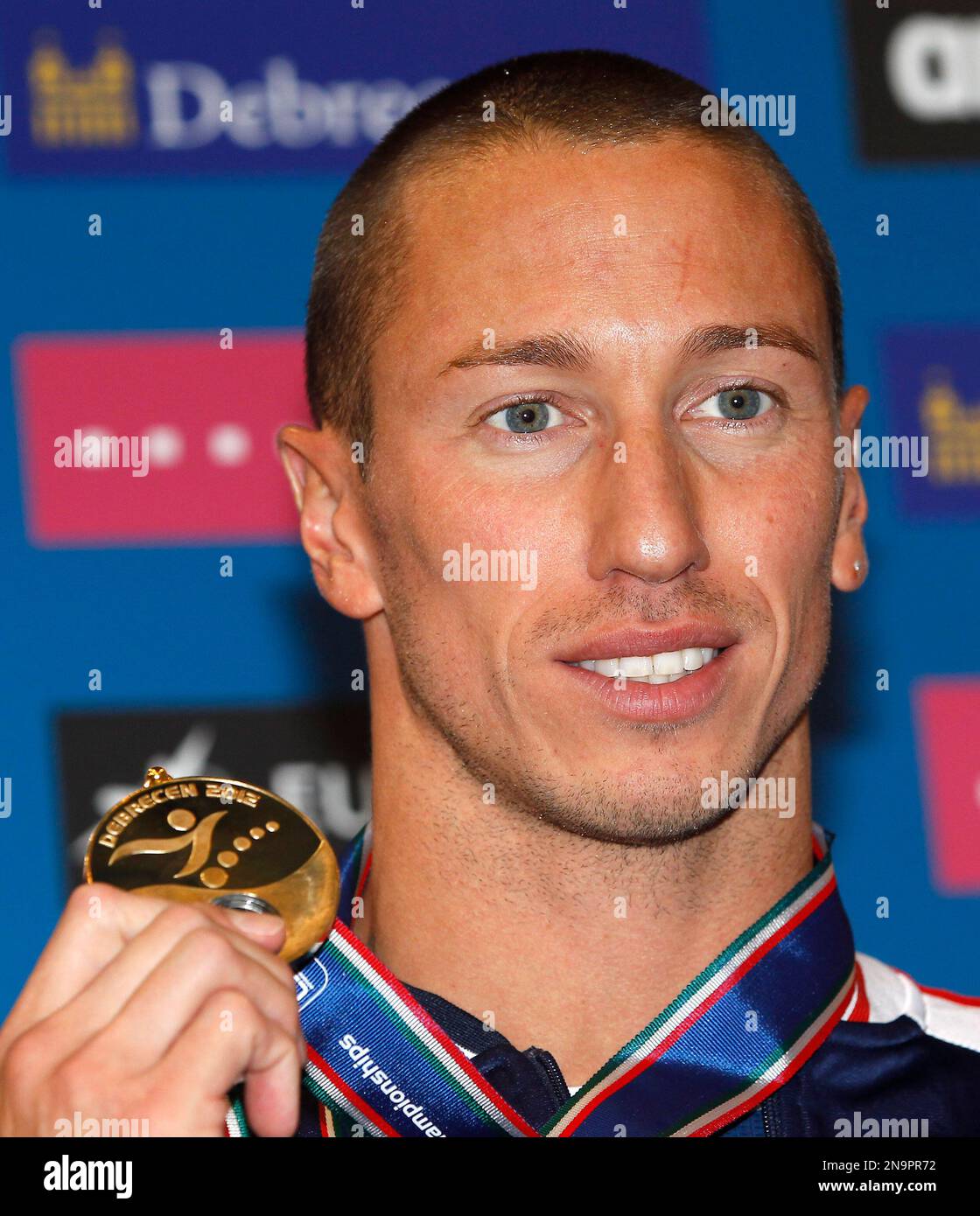 France's Frederick Bousquet displays the gold medal he won in the 50 ...