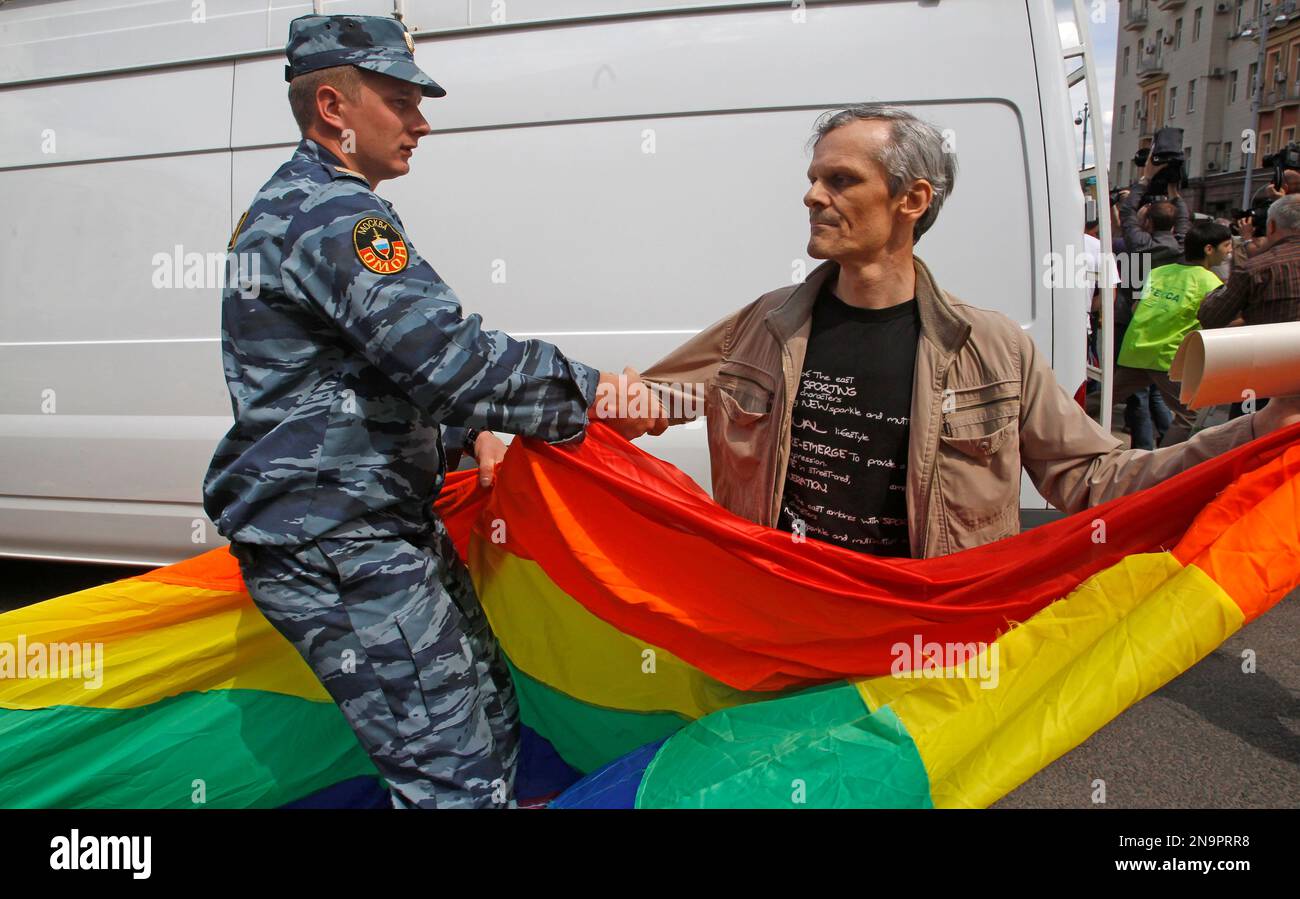 Russian police officer detain a gay rights activist with his flag ...