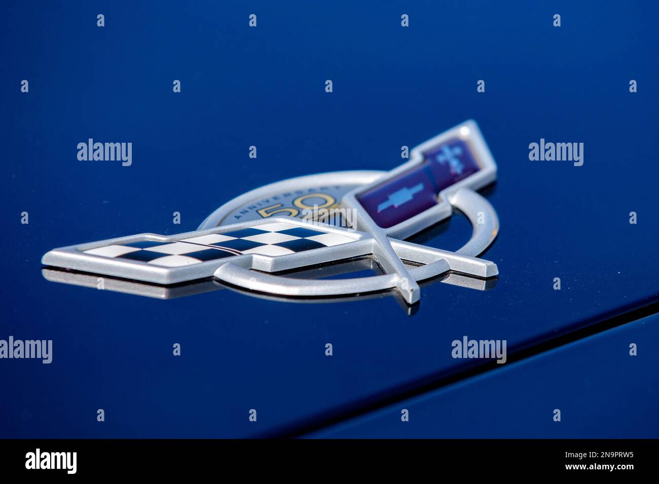 A closeup of the symbol of a blue Chevrolet Corvette Sport Car Stock ...