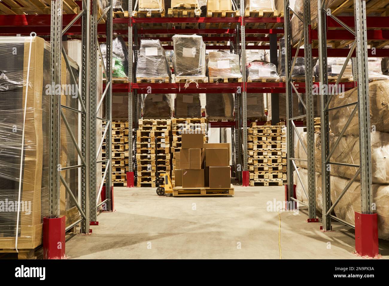 Wide angle view at storage warehouse interior with stack of boxes, copy ...