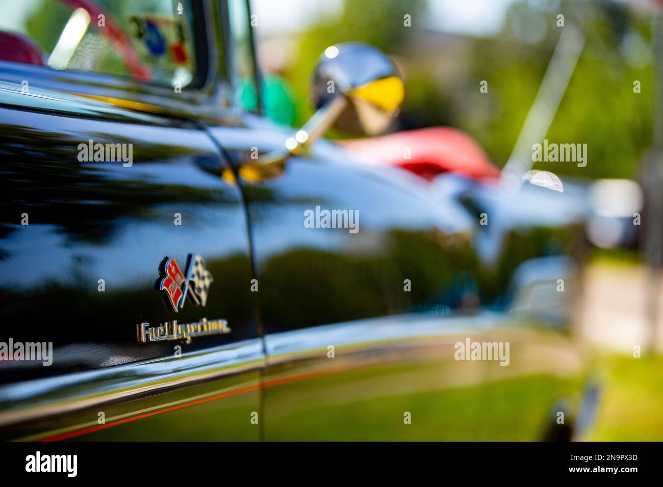 A side view of a shiny Chevrolet Bel Air Classic Car with mirror in the ...