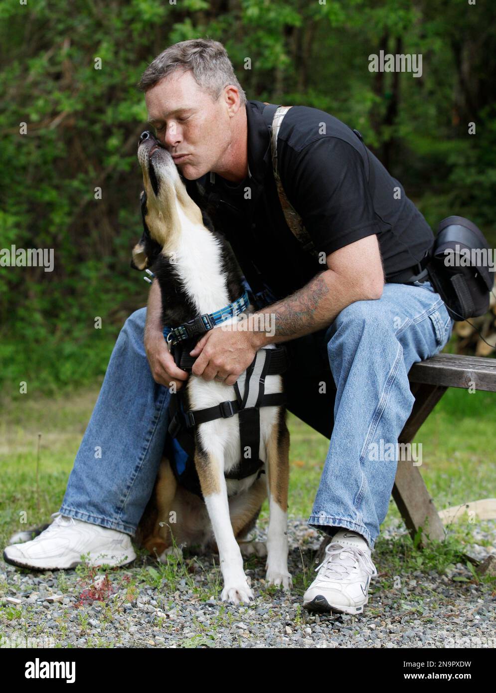 U.S. Army Spc. Mike Ballard poses for a photo with Apollo, his service ...