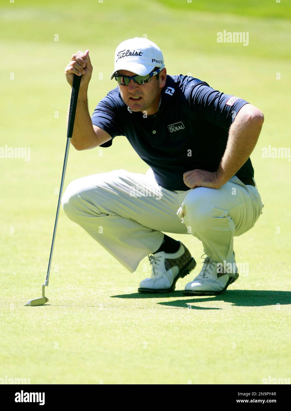 Ben Curtis of the United States reads a putt on the 13th green during ...