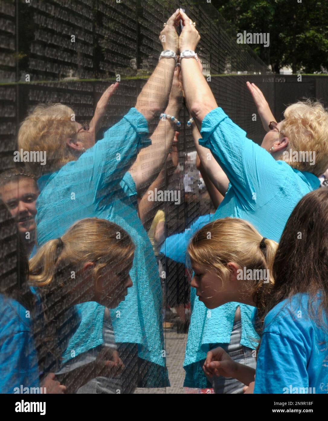People take rubbings of names of fallen etched on the wall of the ...