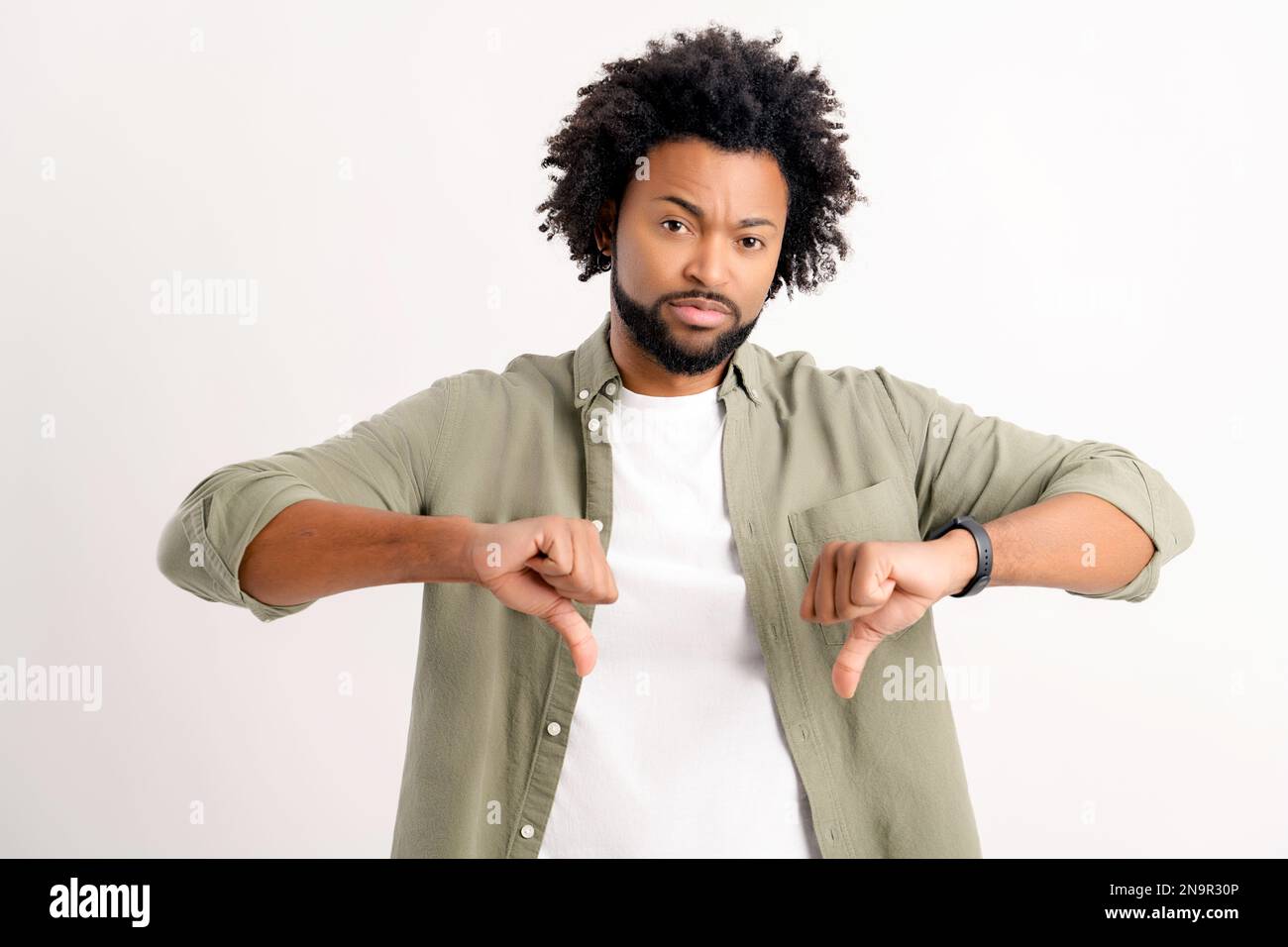 Upset unsatisfied man showing thumbs down with isolated on white ...