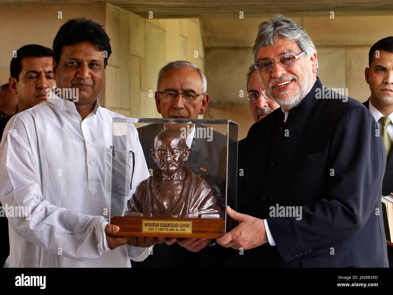 Paraguay President Fernando Lugo Mendez, right, is presented with a ...
