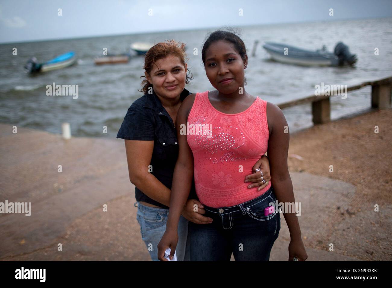 Nely, right, and Daisy pose for a picture in Puerto Lempira's harbor ...