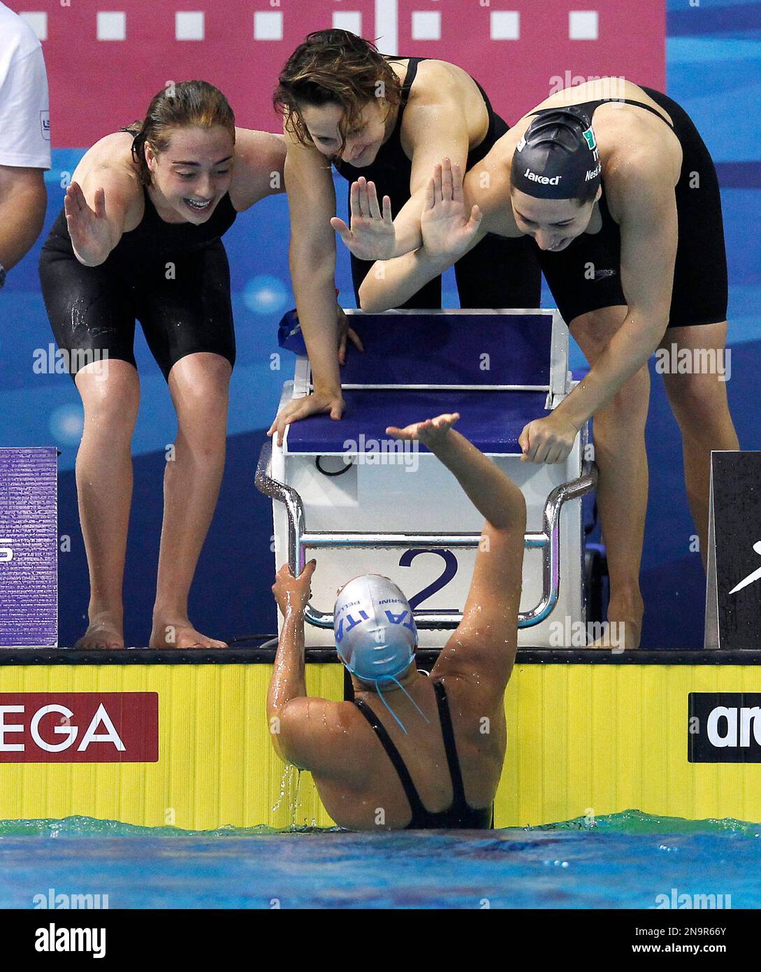 Italy's team celebrates after winning the Women's 4x200 meter Freestyle ...
