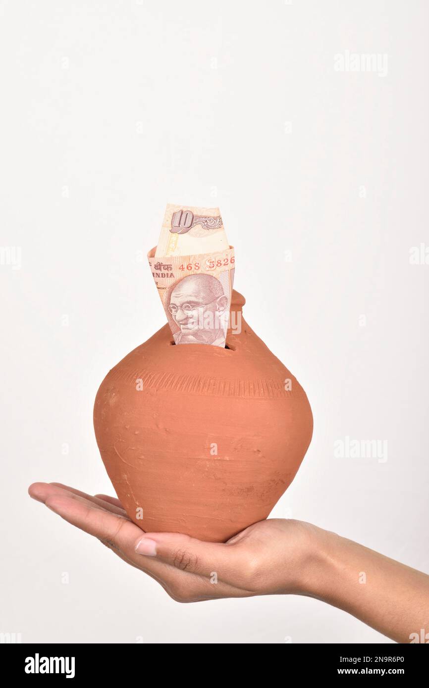 Gullak in hand on white background, money saving in india Stock Photo ...