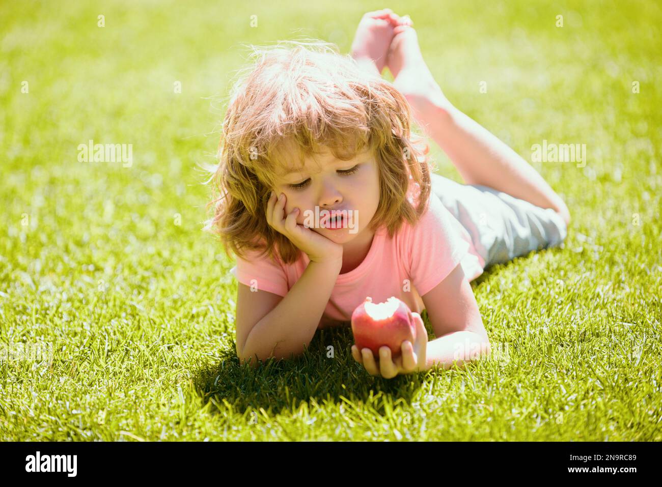 Kid eat apple outdoor. Healthy boy nutrition for kids. Fruit snack ...