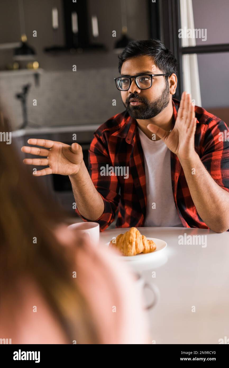Happy indian couple having breakfast and small talk together in the ...