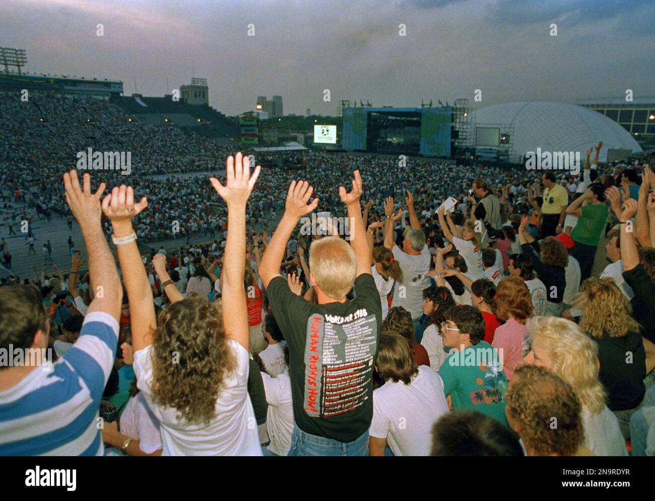 Fans cheer as they pack Philadelphia's JFK Stadium for the Amnesty International " Human Rights ...