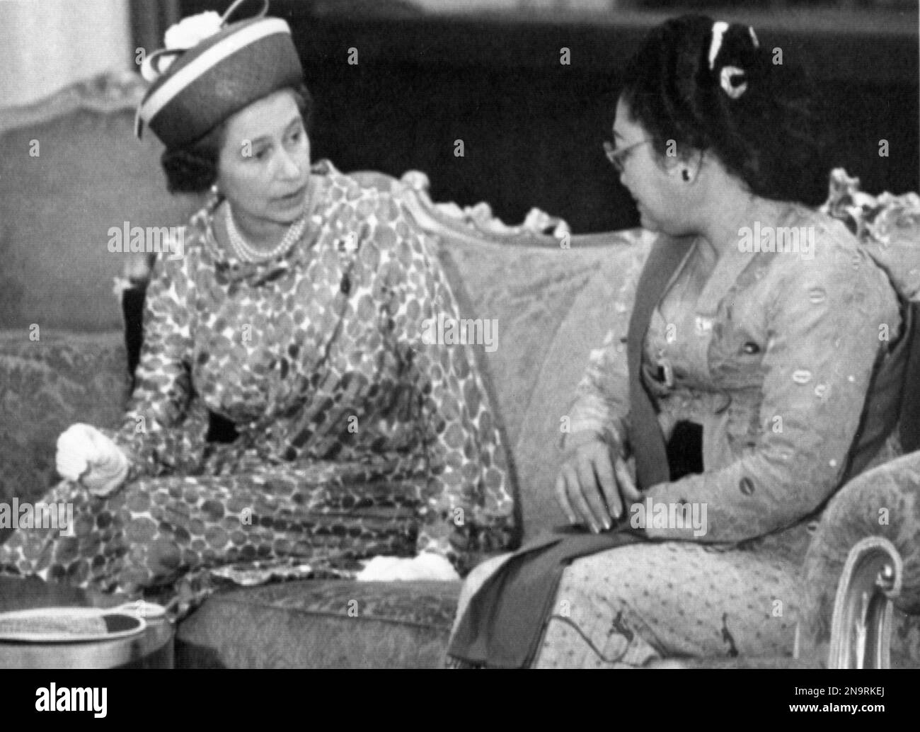 Britain's Queen Elizabeth II, left, talks with Siti Suharto, the First ...