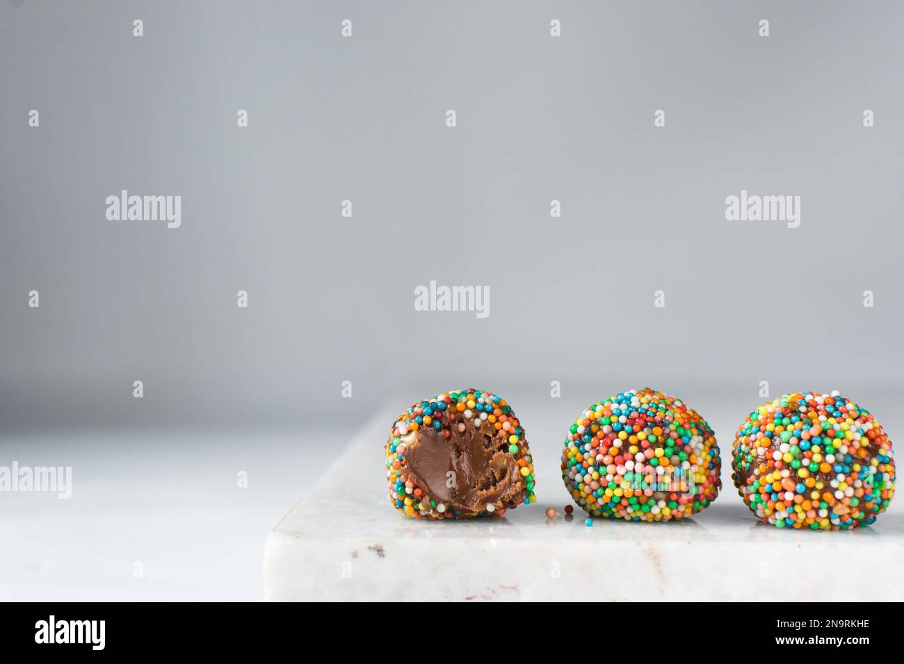 sprinkles coated chocolate truffles on a white tray, homemade chocolate ...