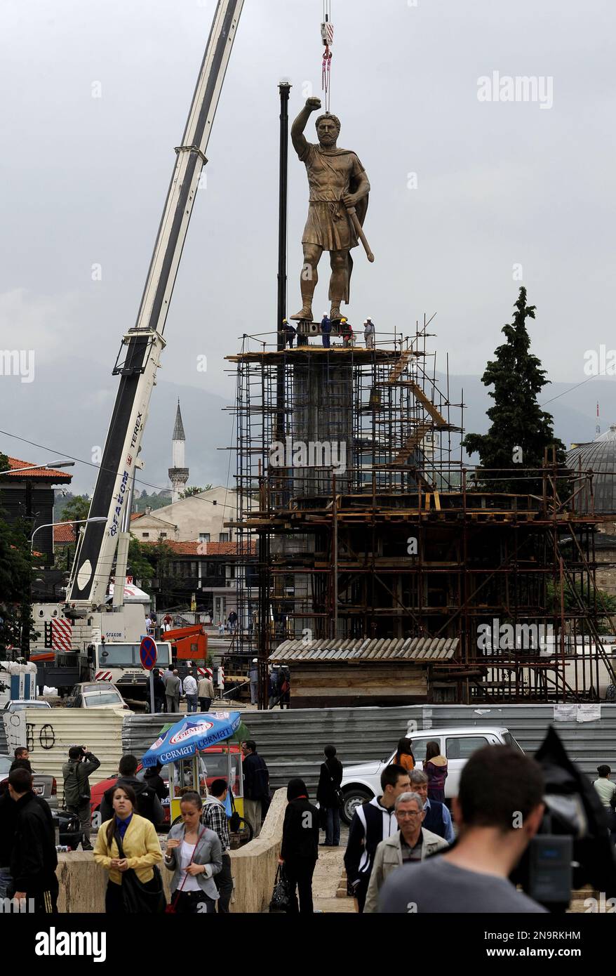 Workers place a 13-meter-high bronze statue named as "Warrior" on a 15 ...