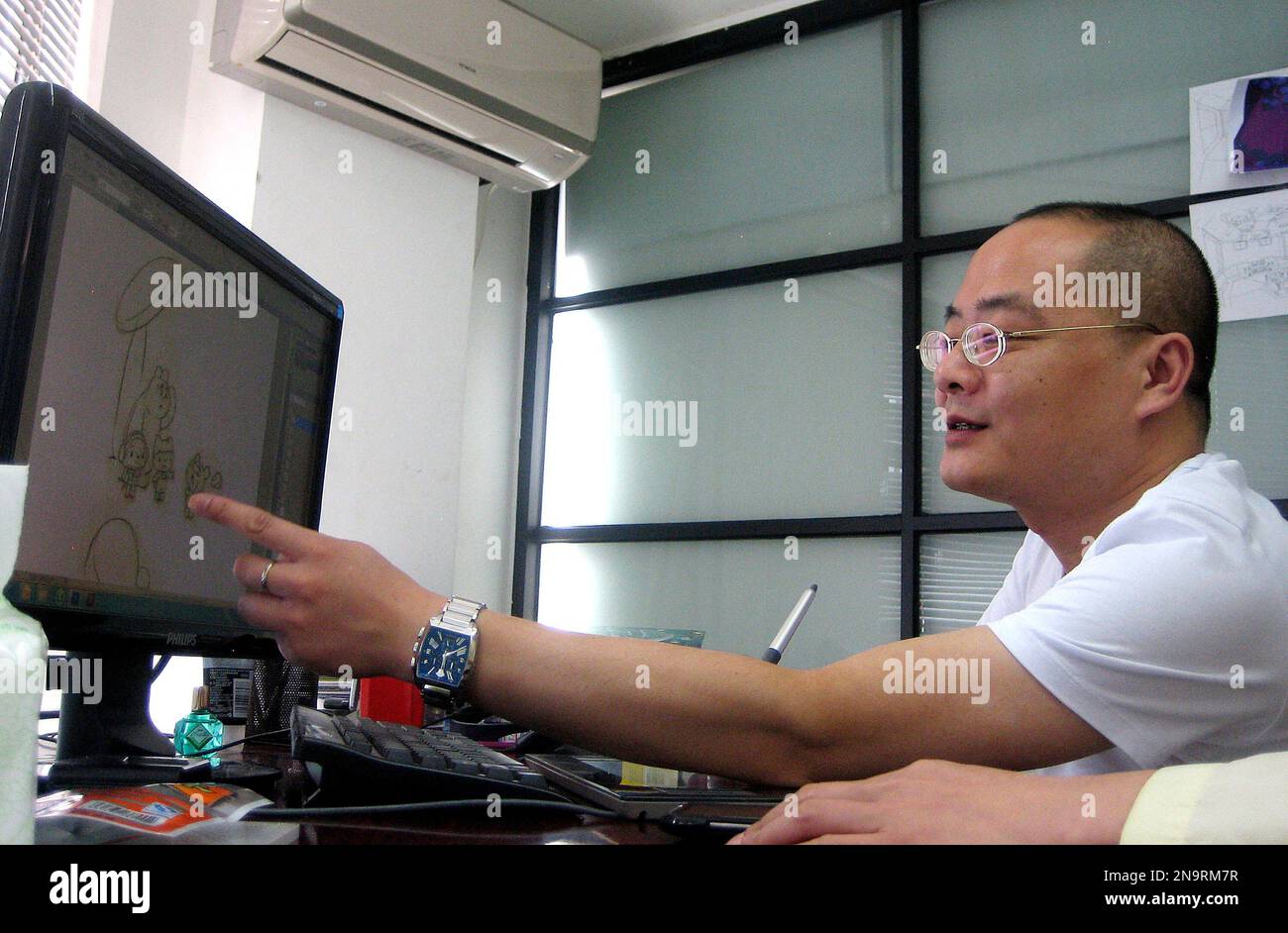 In this Oct. 12, 2011 photo, a staff artist who works under Chinese ...