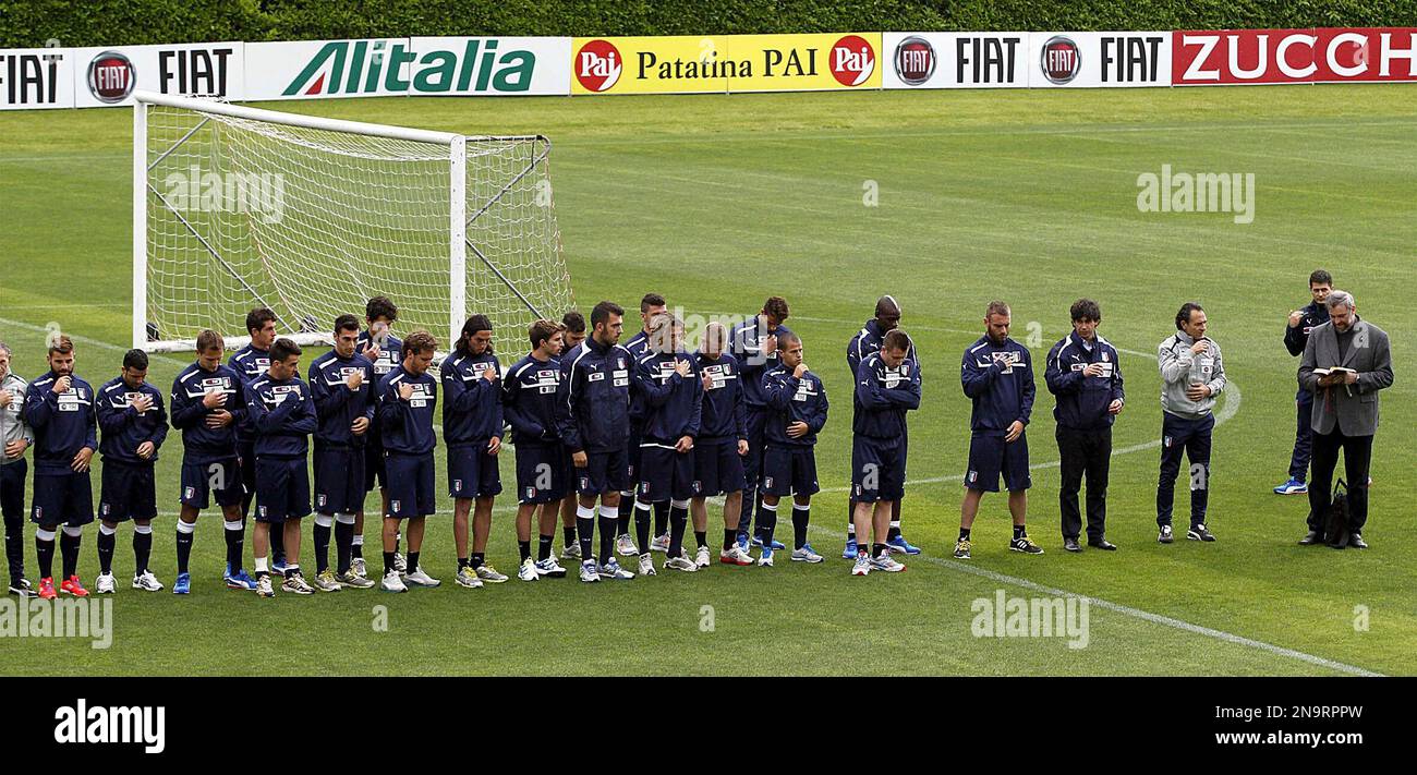 Italian national soccer team's players line up as priest Don Massimiliano, right, delivers his ...