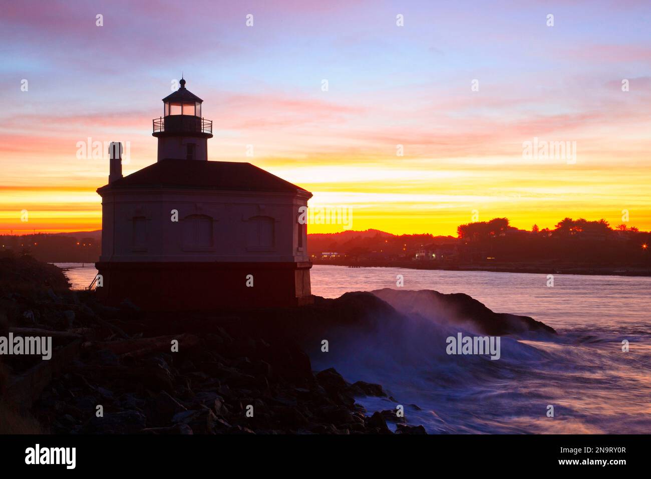 Coquille River Light on the rugged and rocky Oregon coast with golden ...