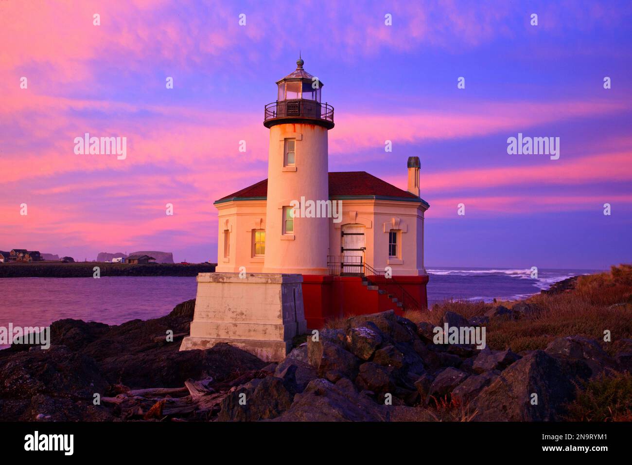 Coquille River Light on the rugged and rocky Oregon coast with golden ...