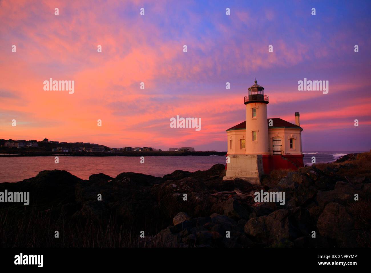 Coquille River Light on the rugged and rocky Oregon coast with golden ...