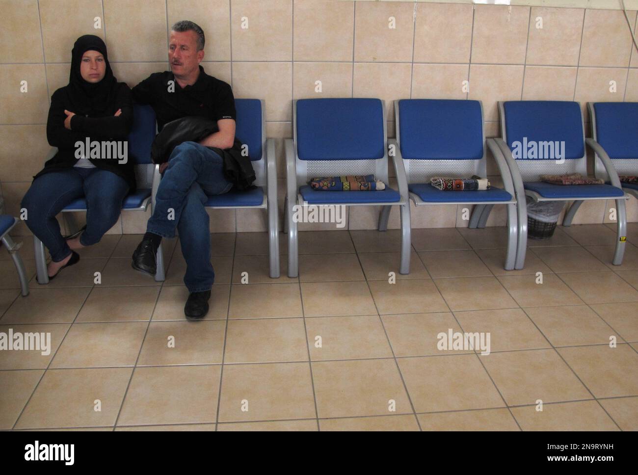Palestinian activist Bassem Tamimi sits with his wife as they wait for ...