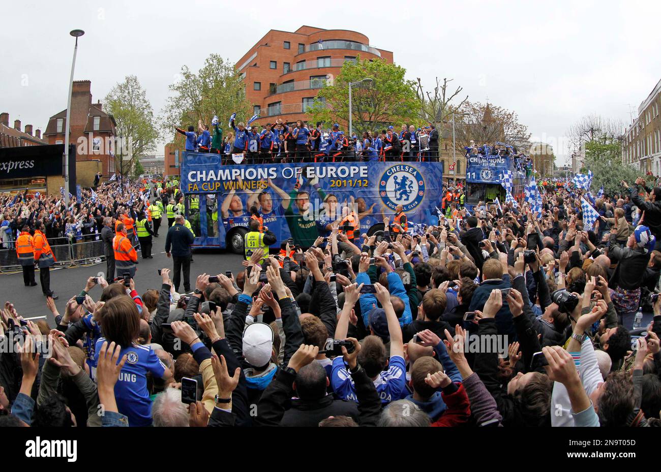 Chelsea players with their trophies on an open-top bus parade through ...
