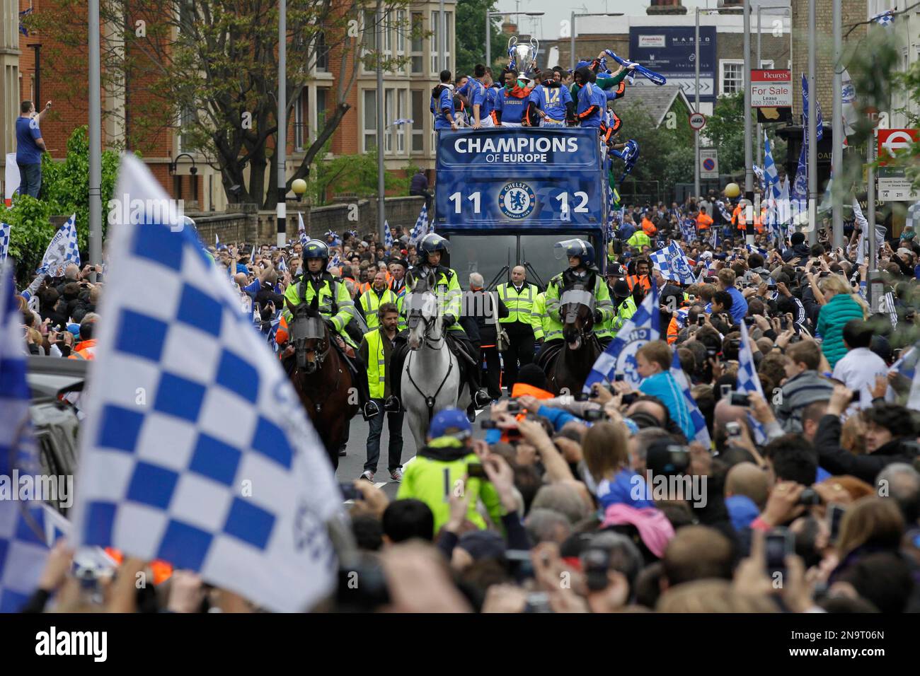 Chelsea players on an open-top bus parade through the streets near ...