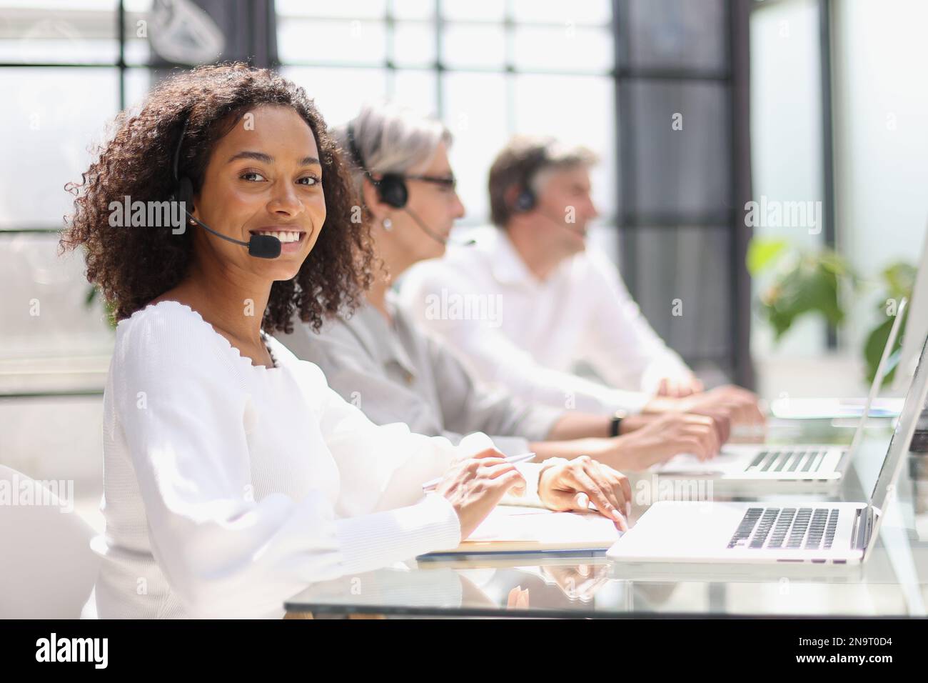 african american operator smiling in a call center Stock Photo - Alamy