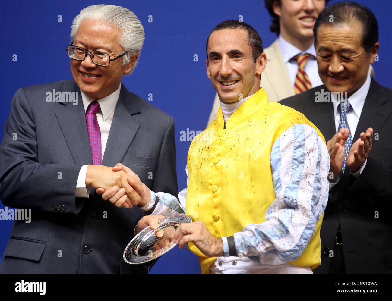 French jockey Olivier Doleuze, center, who rode horse Chinchon receives ...