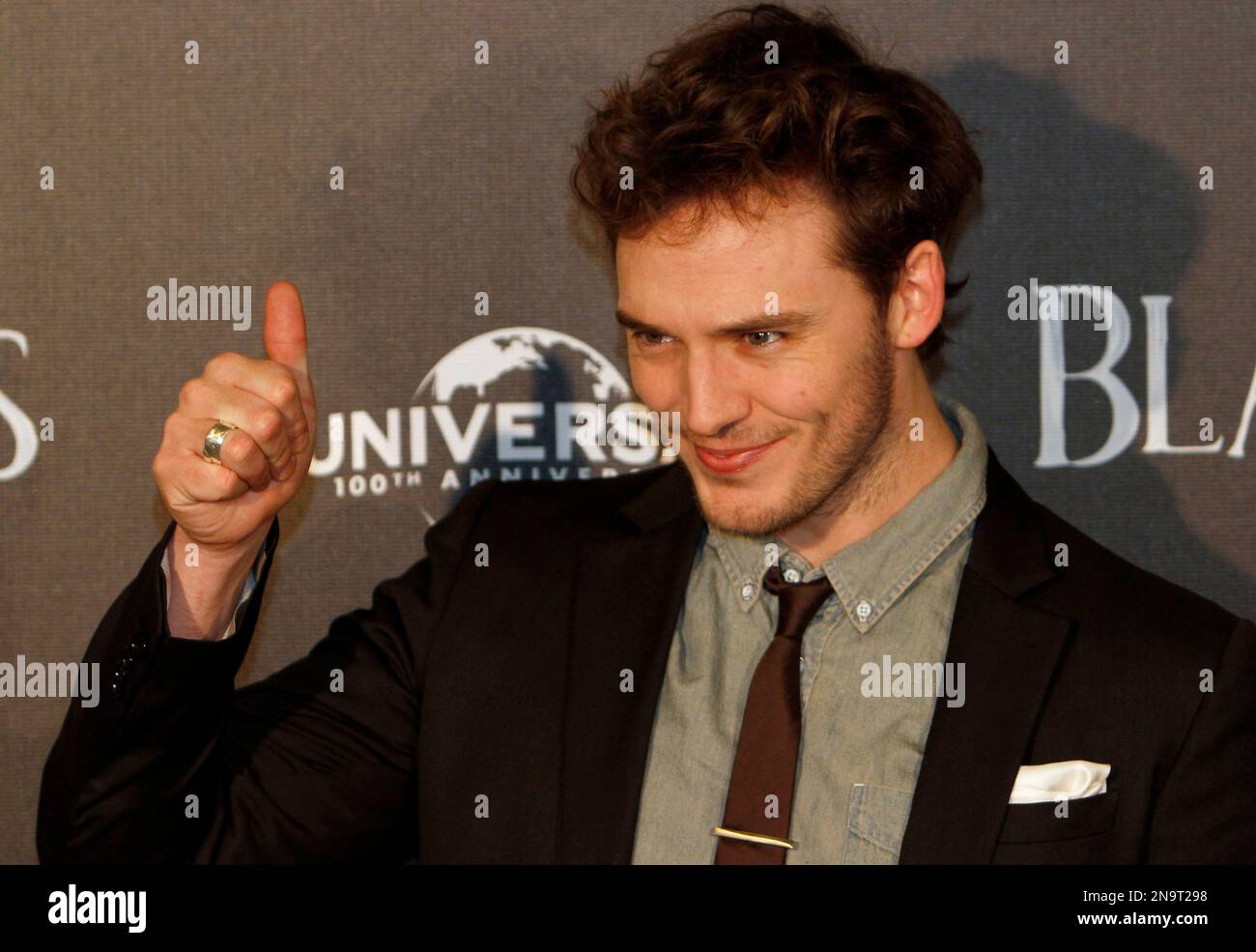 British actor Sam Claflin poses for photos as he arrives for an event ...