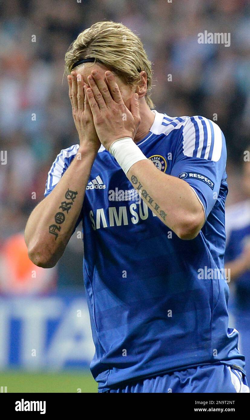 Chelsea's Fernando Torres holds his face after missing a scoring chance ...