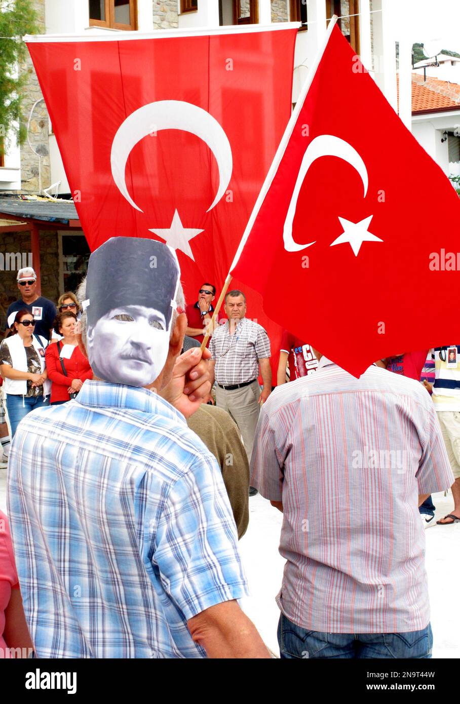 A man wearing a mask of the founder of modern Turkey, Mustafa Kemal ...