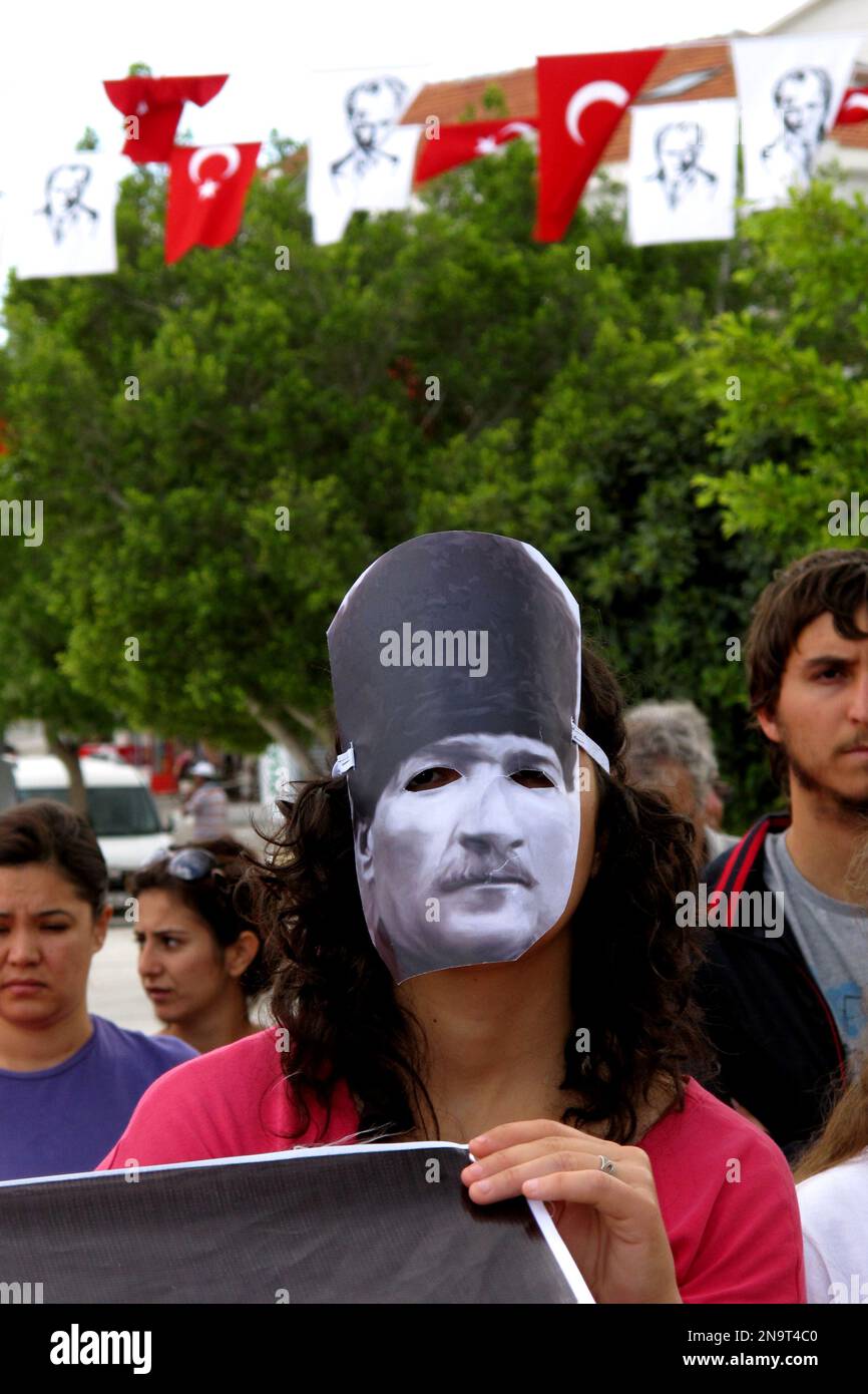 A young woman wears a mask of the founder of modern Turkey, Mustafa ...