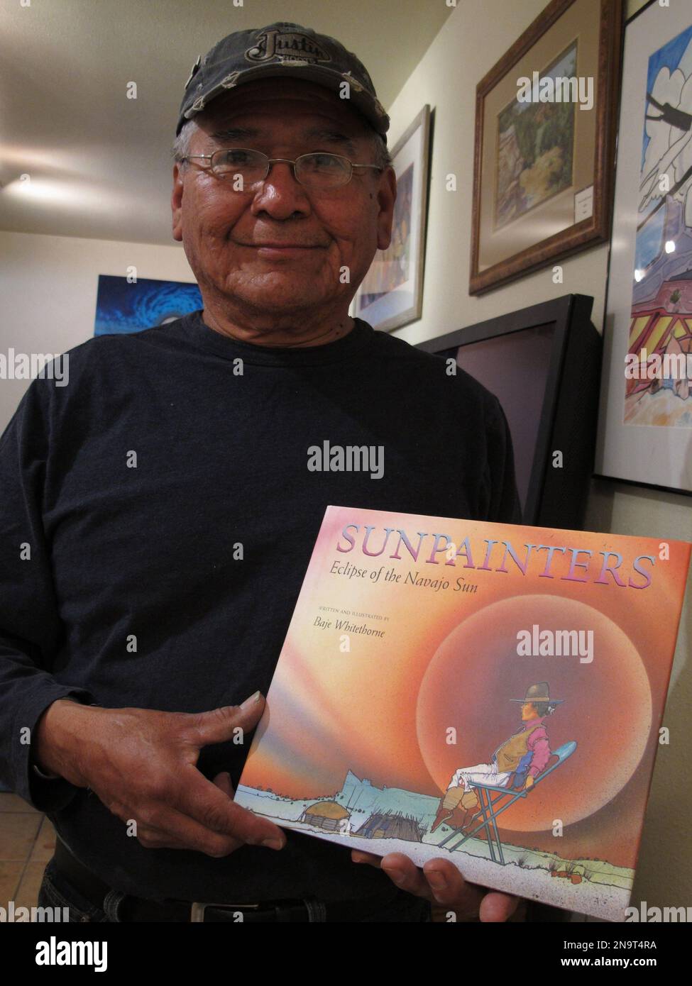 In this May 17, 2012 photo, Baje Whitethorne Sr. displays a book at his ...