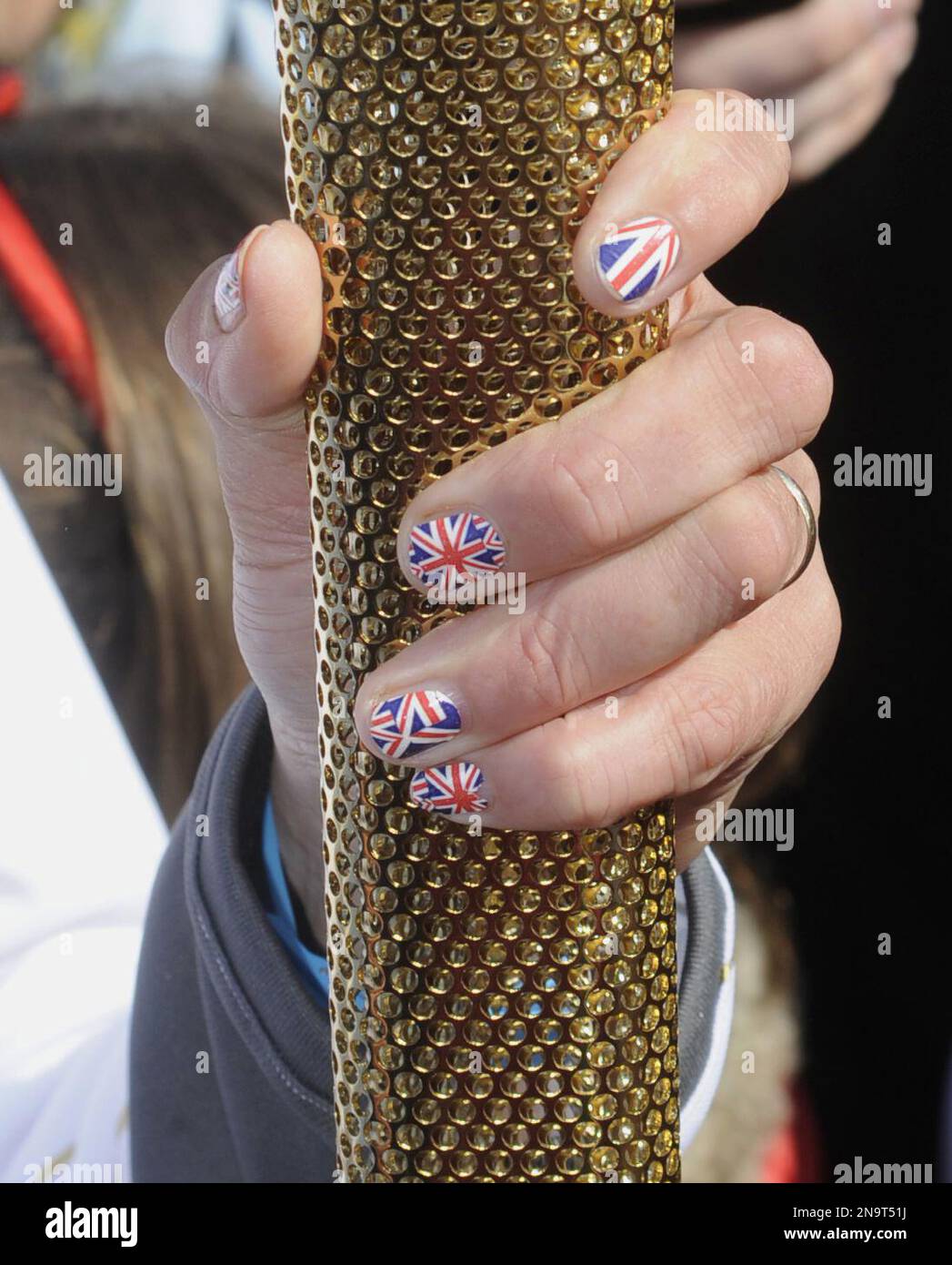 Sarah Blight holds the London 2012 Olympic torch with her patriotic ...