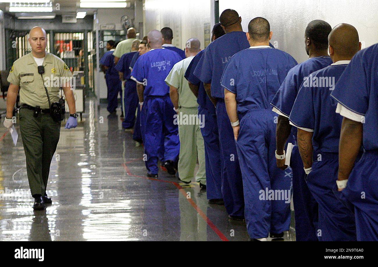 FILE - In this Oct. 27, 2011 photo, a deputy passes a line of inmates ...