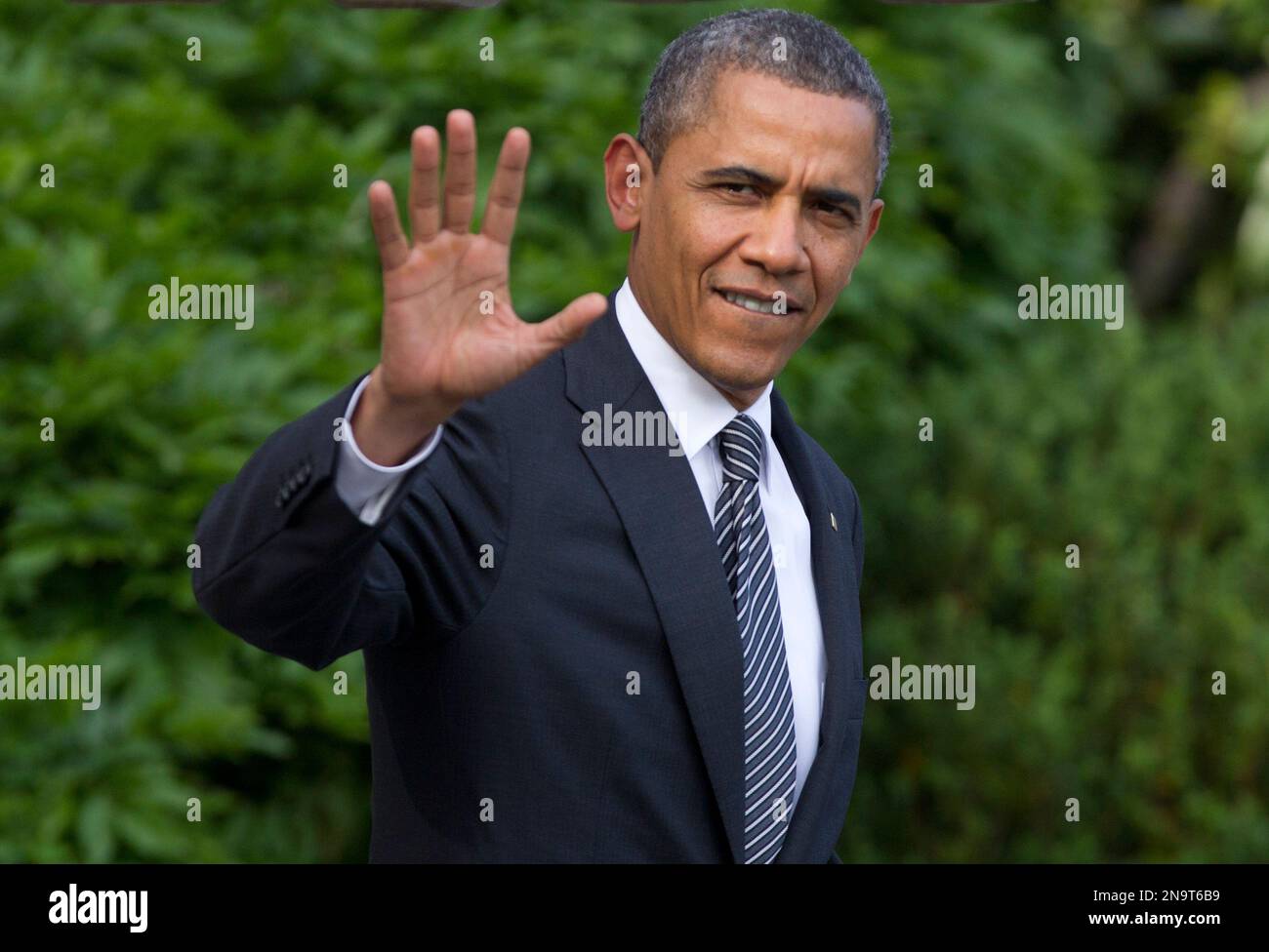 President Barack Obama waves as he walks from the White House in ...