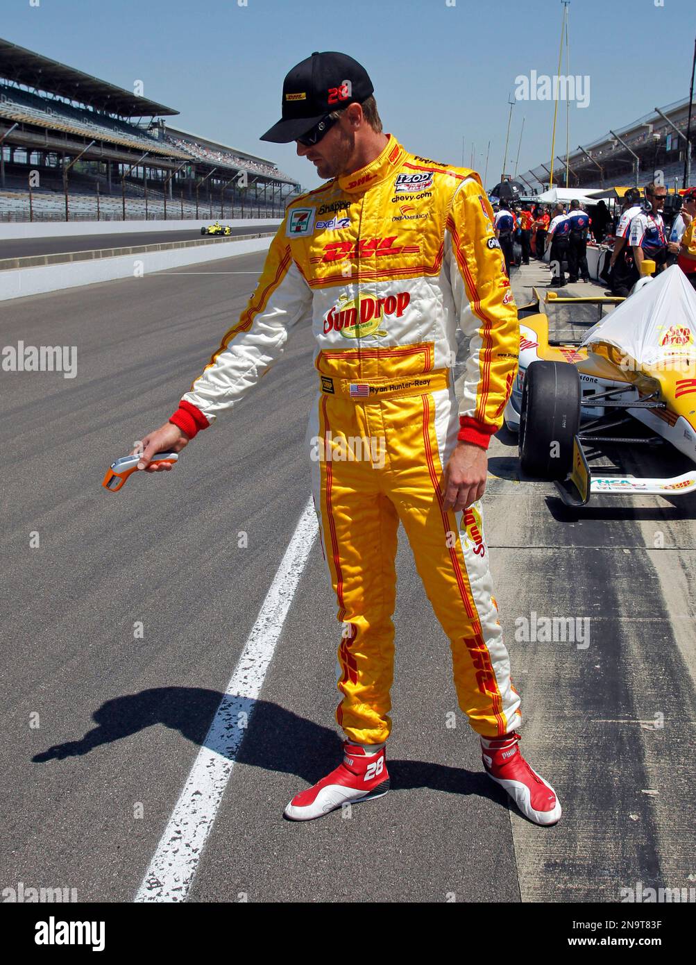 IndyCar driver Ryan Hunter-Reay checks the temperature of the track ...